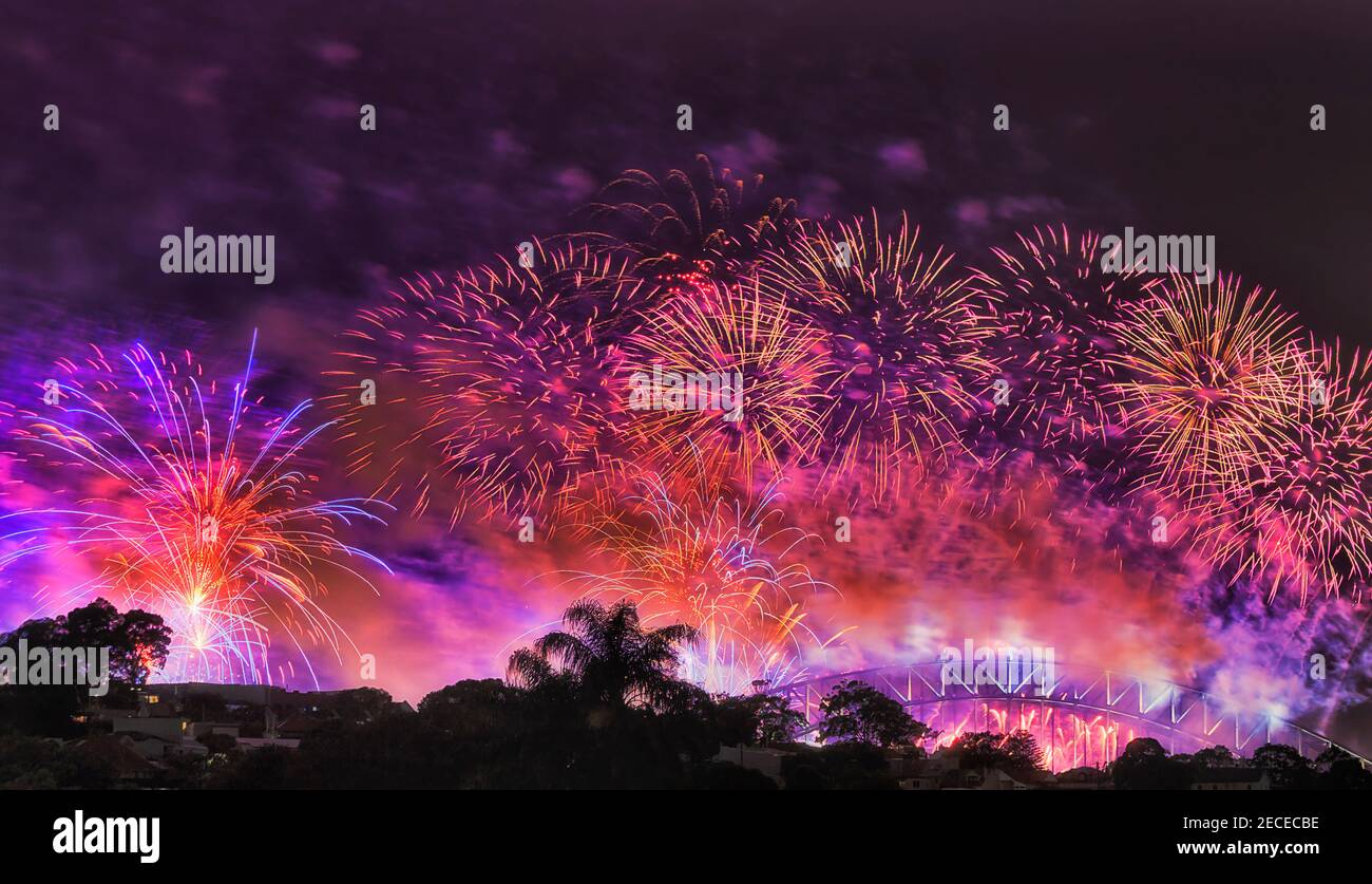 FIre balls over Sydney harbour bridge in dark night sky at New Year ...