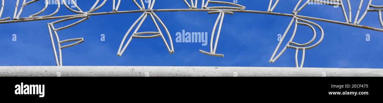 County fair sign is framed by blue sky. Sign is made out of iron and ...