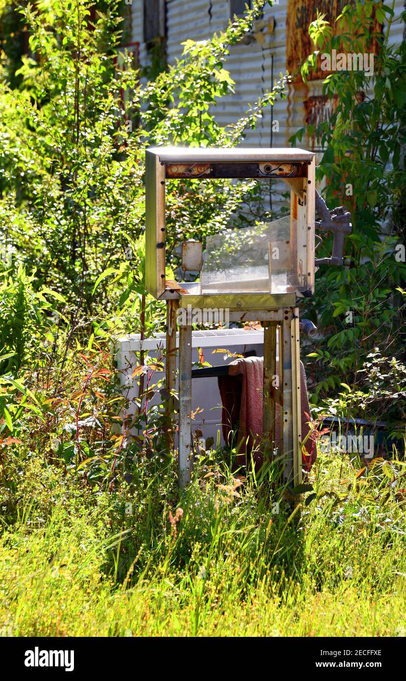 Discarded old gas pump still stands barely remains standing besides ...