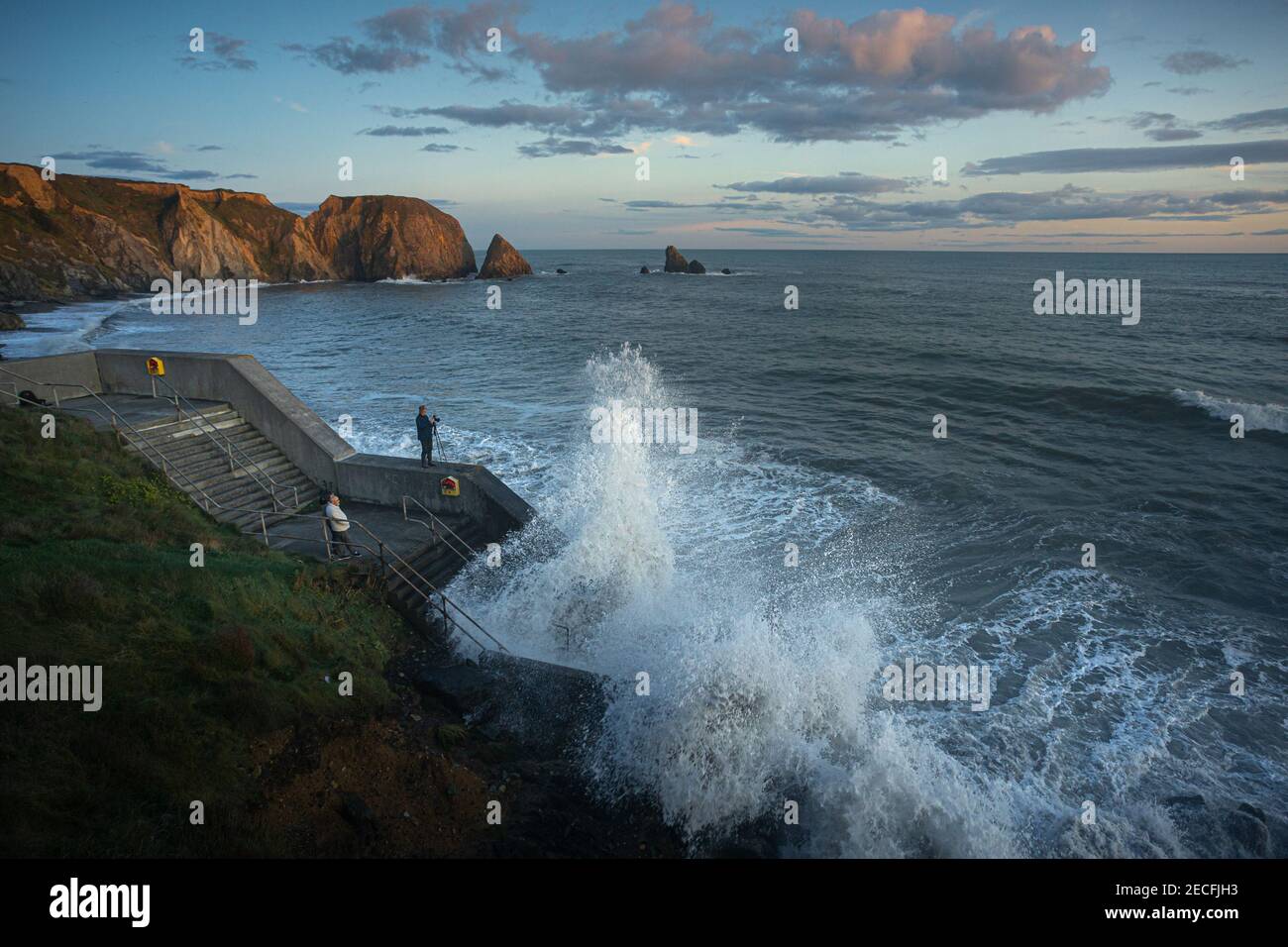 photographer on the beach on the Cooper coast of Waterford, Ireland ...