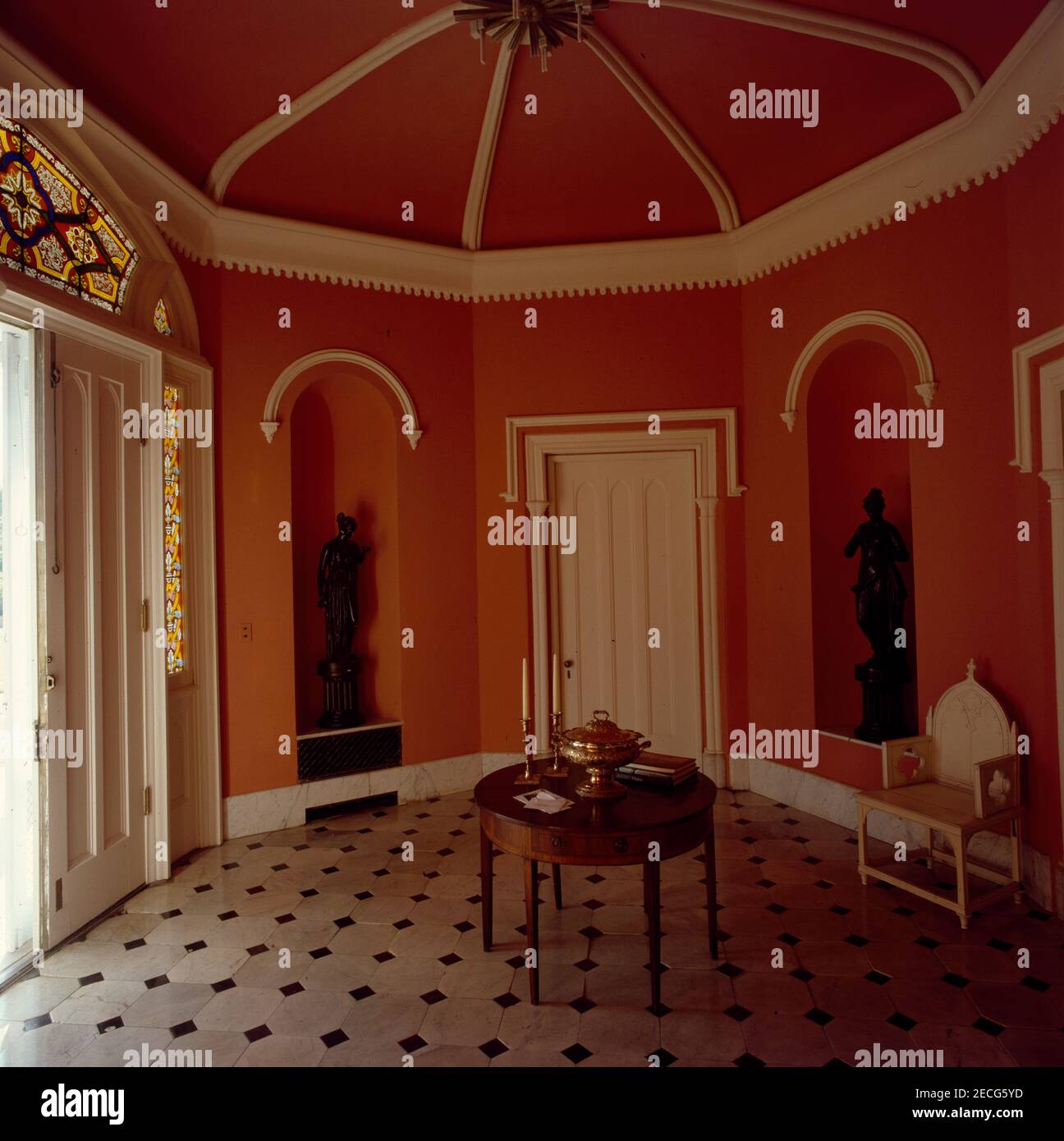 Circular hall with plaster decorating, black and white tiled floor and ...