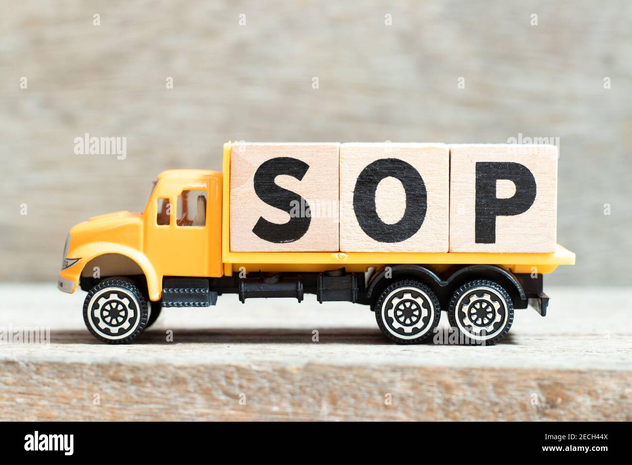 Toy truck hold alphabet letter block in word SOP (Abbreviation Standard ...