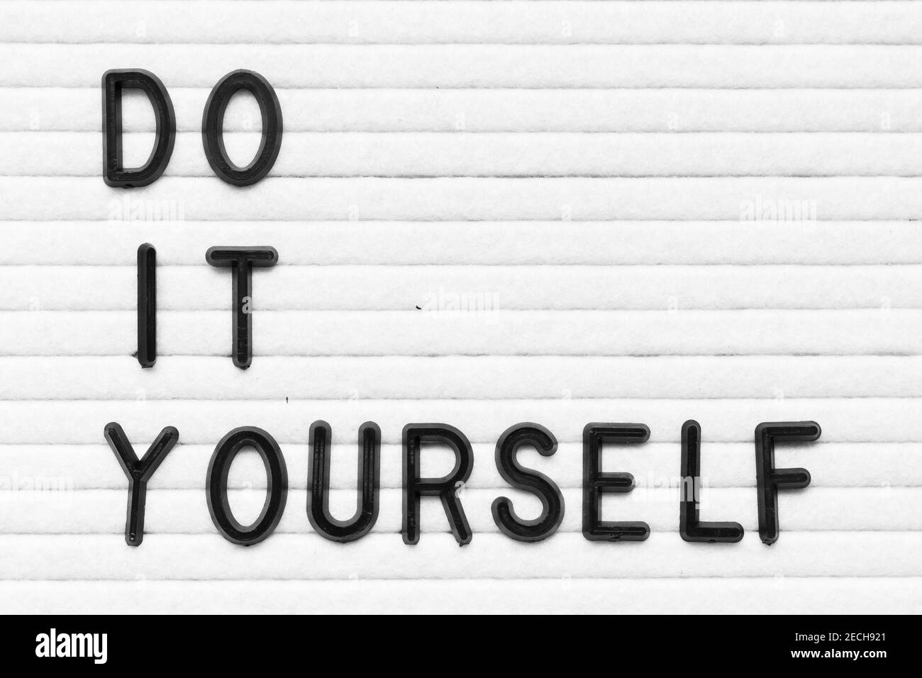 Black color letter in word do it yourself on white felt board ...