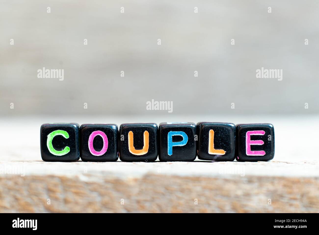 Black bead with color letter in word couple on wood background Stock ...