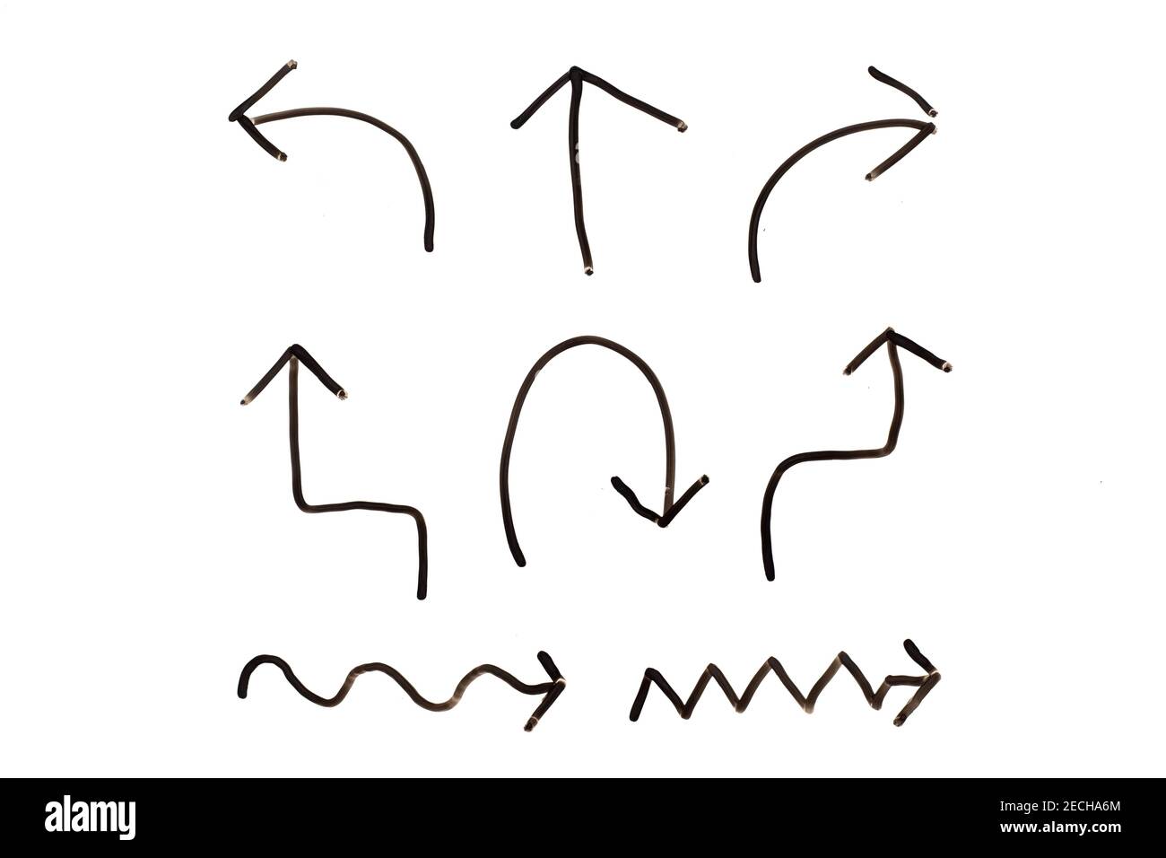 Set of black handdrawing in multiple shape of arrow symbol on white ...