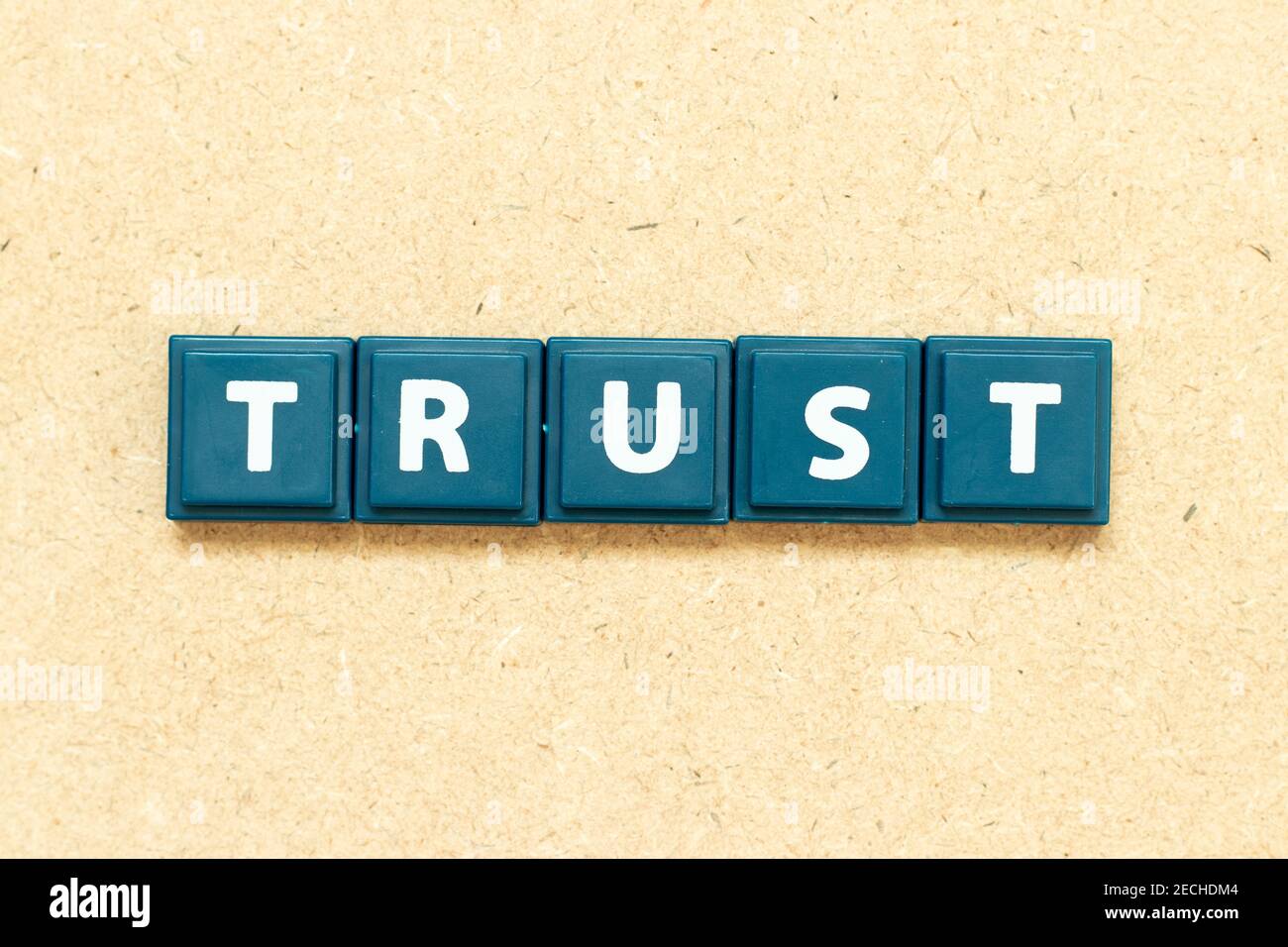 Tile alphabet letter in word trust on wood background Stock Photo - Alamy