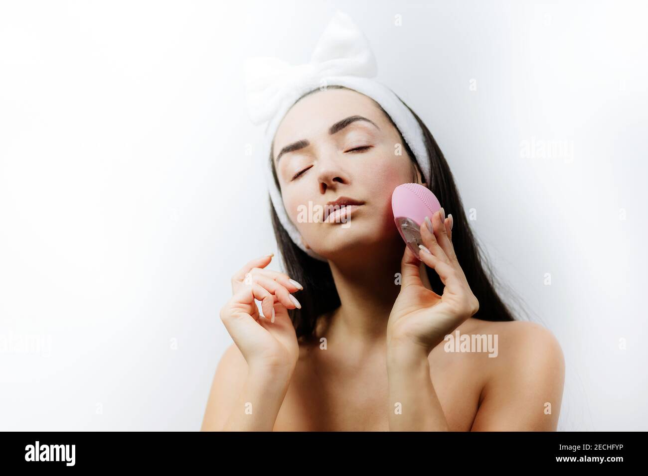 happy woman using deep cleansing face tool Stock Photo - Alamy