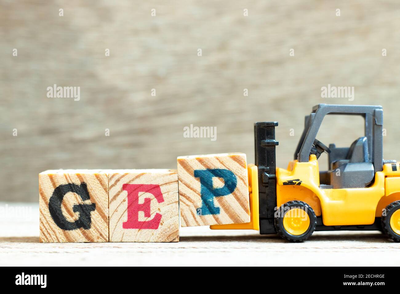 Toy forklift hold letter block p to complete word GEP (abbreviation of ...
