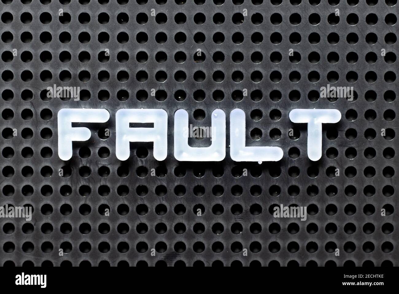 White color alphabet with word fault on black pegboard background Stock ...