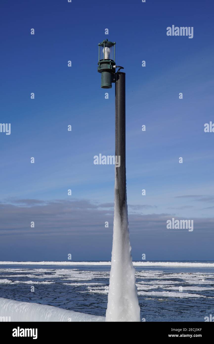 Grand Haven, Michigan, February 2021, Ice covered lamppost, blue sky ...