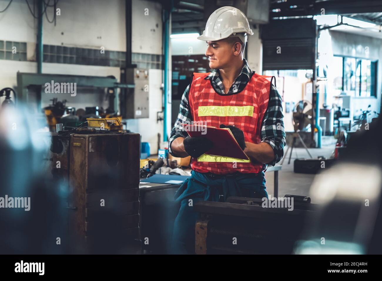 Manufacturing worker working with clipboard to do job procedure ...