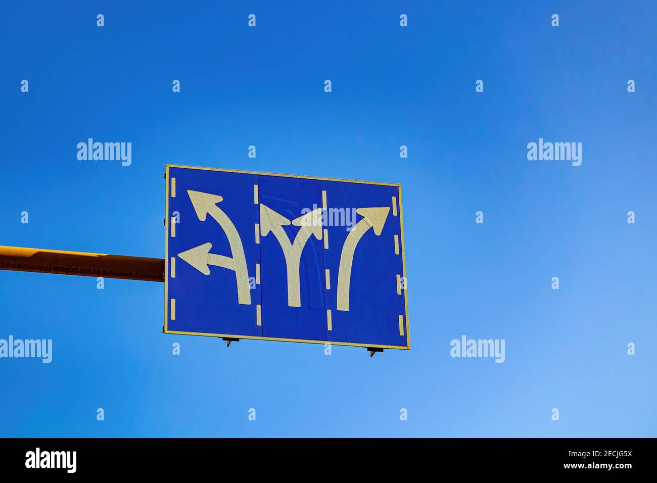 Blue and white sign, indicating what or which ways traffic can move ...