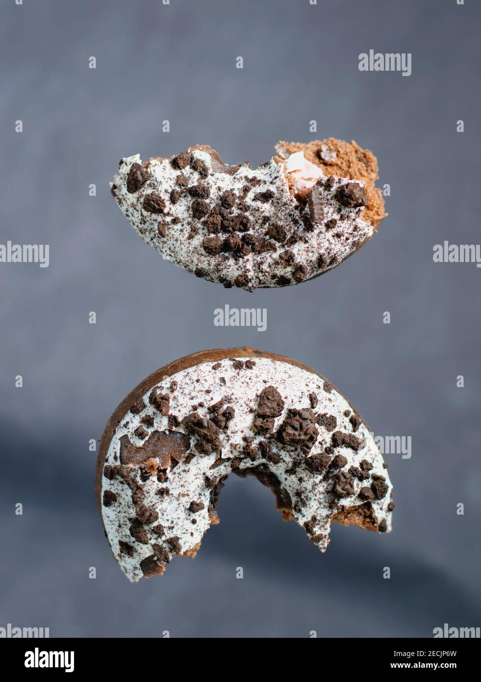 Broken levitating donut pieces on a grey background Stock Photo - Alamy
