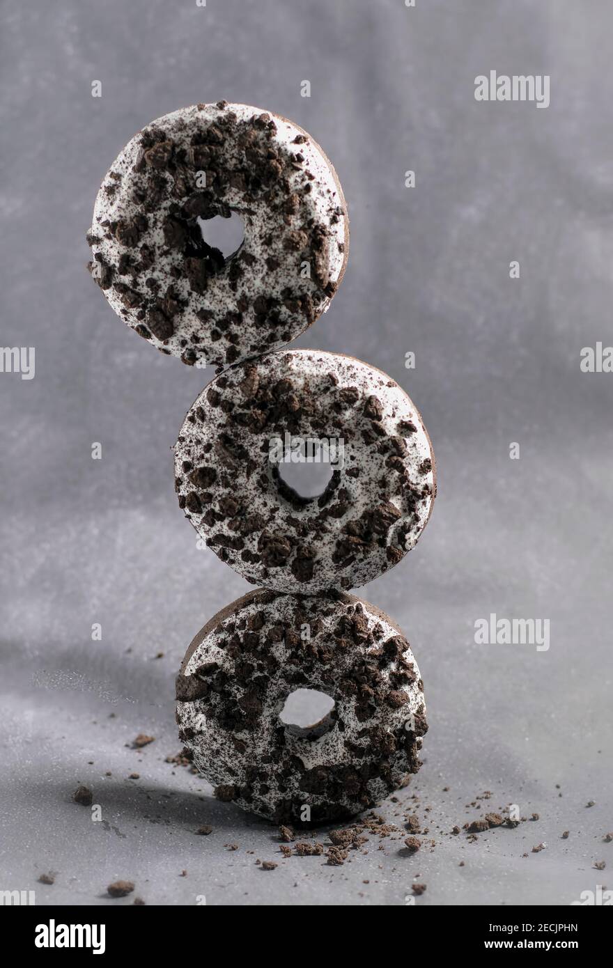 Three donuts on a grey background Stock Photo - Alamy