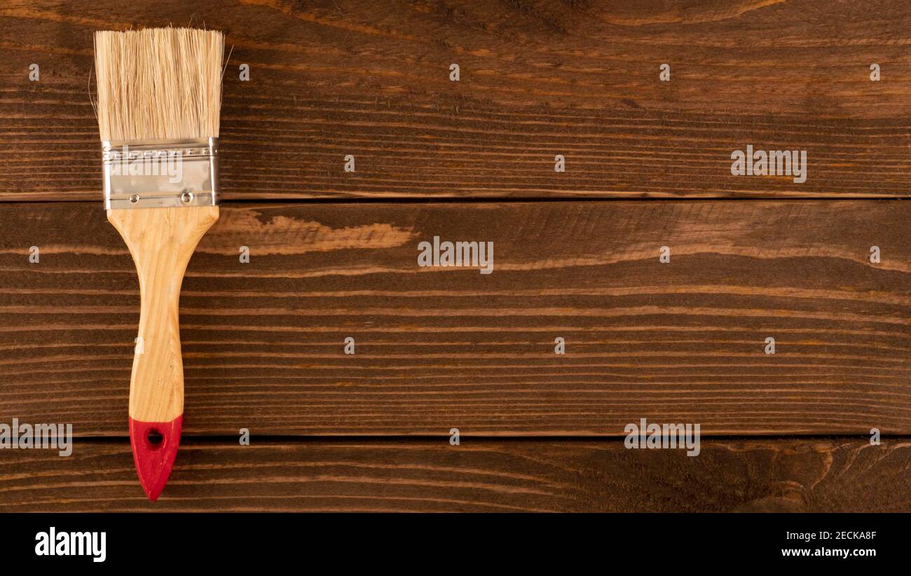 Construction brushes on a wood background. Texture from the ...