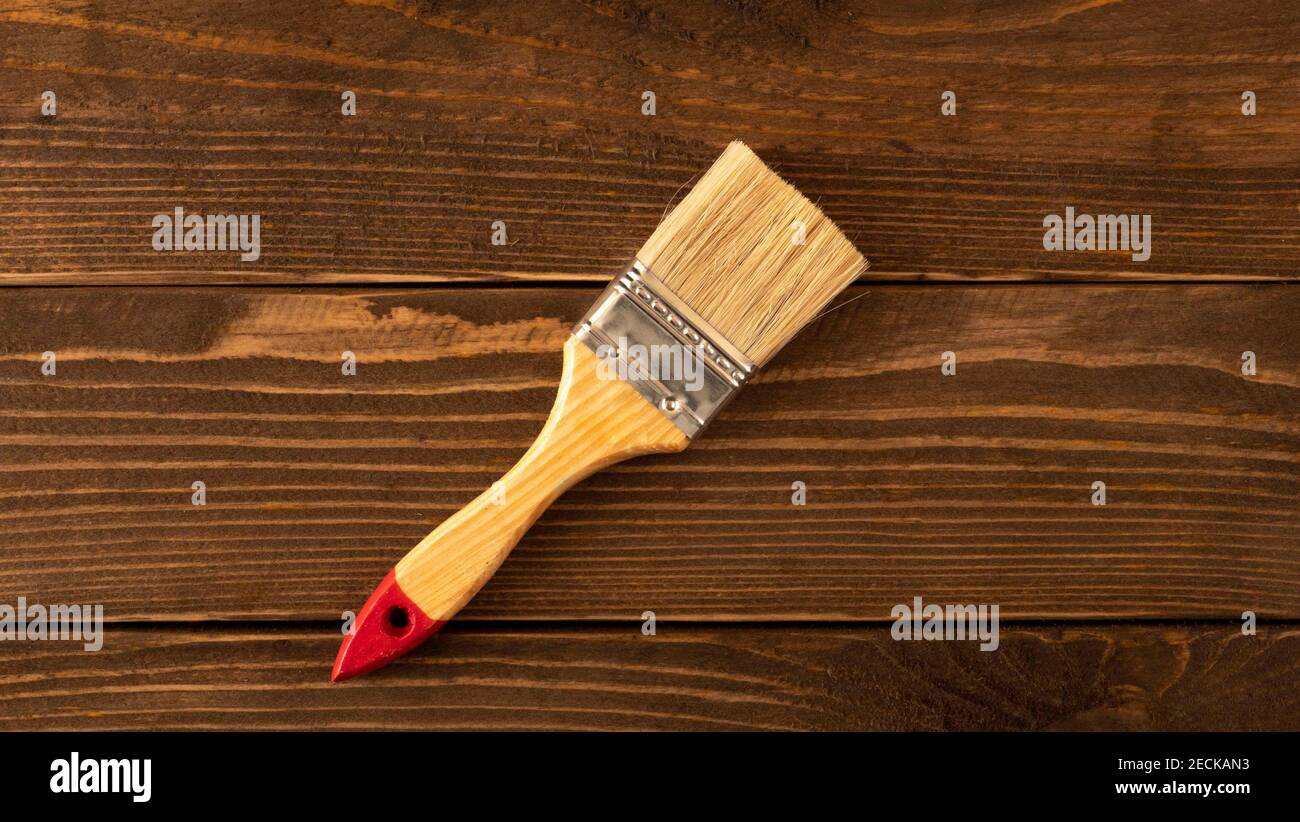 Construction brushes on a wood background. Texture from the ...
