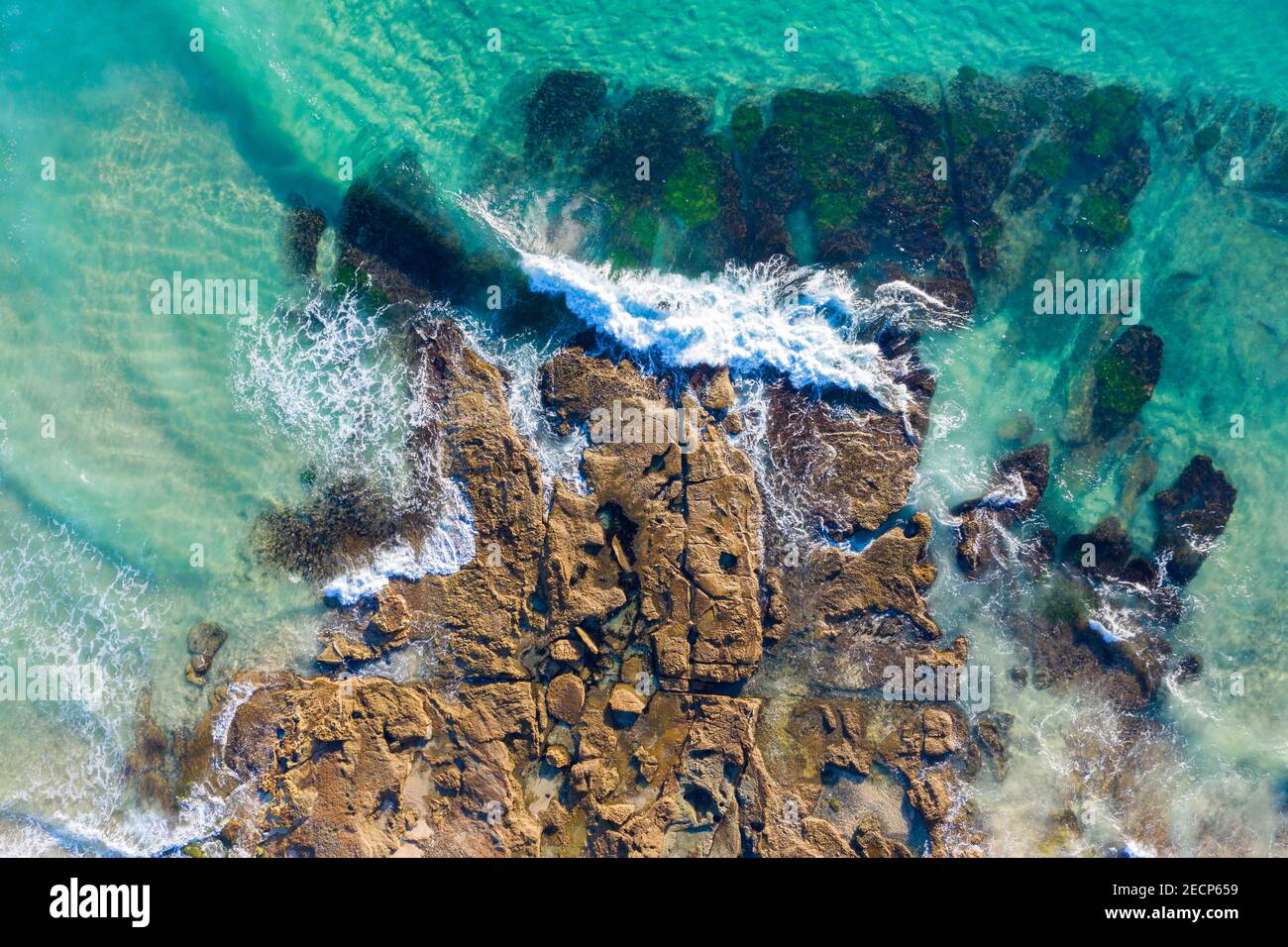 Catherine Hill Bay aerial view of waves breaking on the rocky shore ...