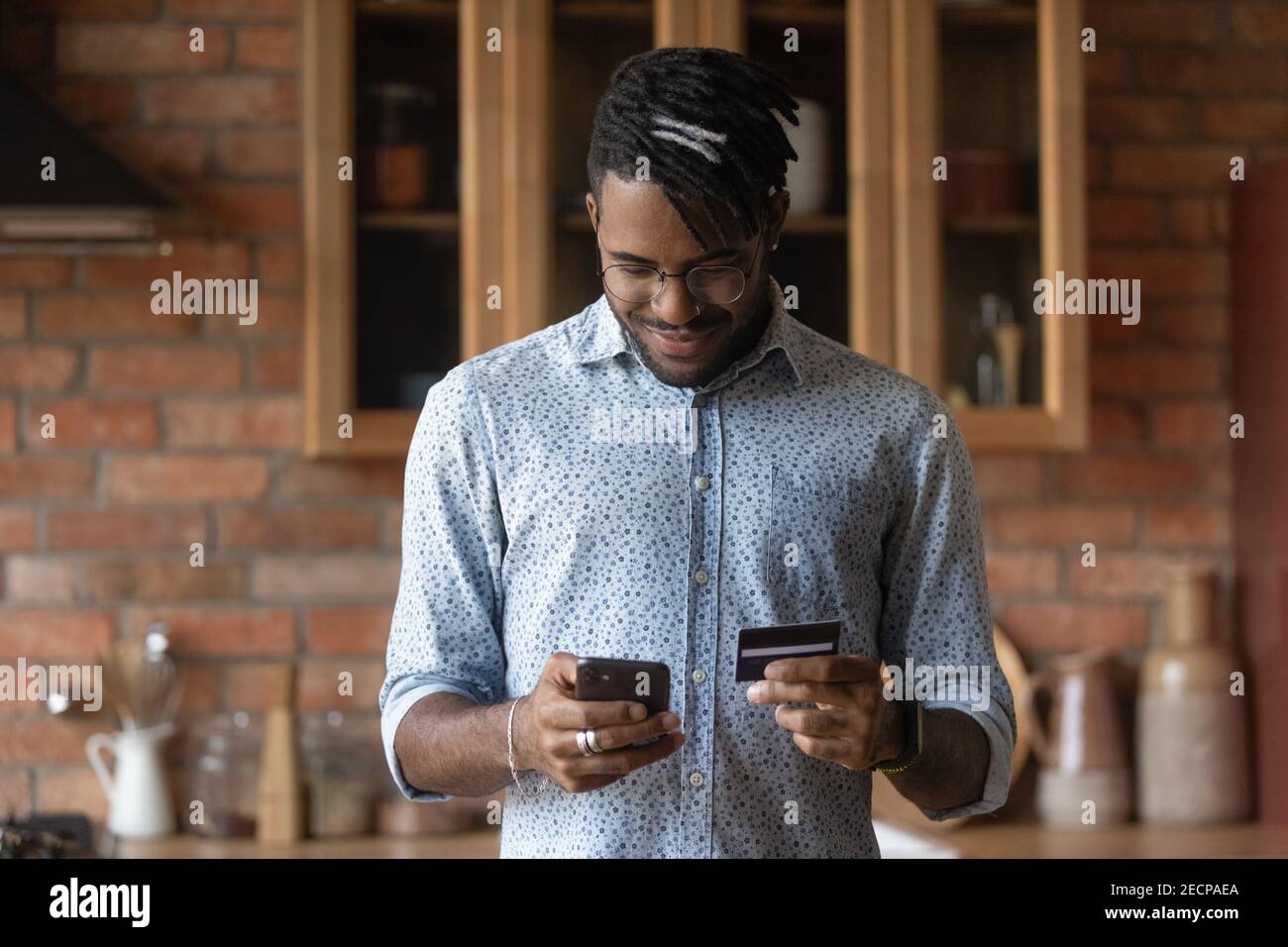 Black man transaction mobile phone hi-res stock photography and images ...