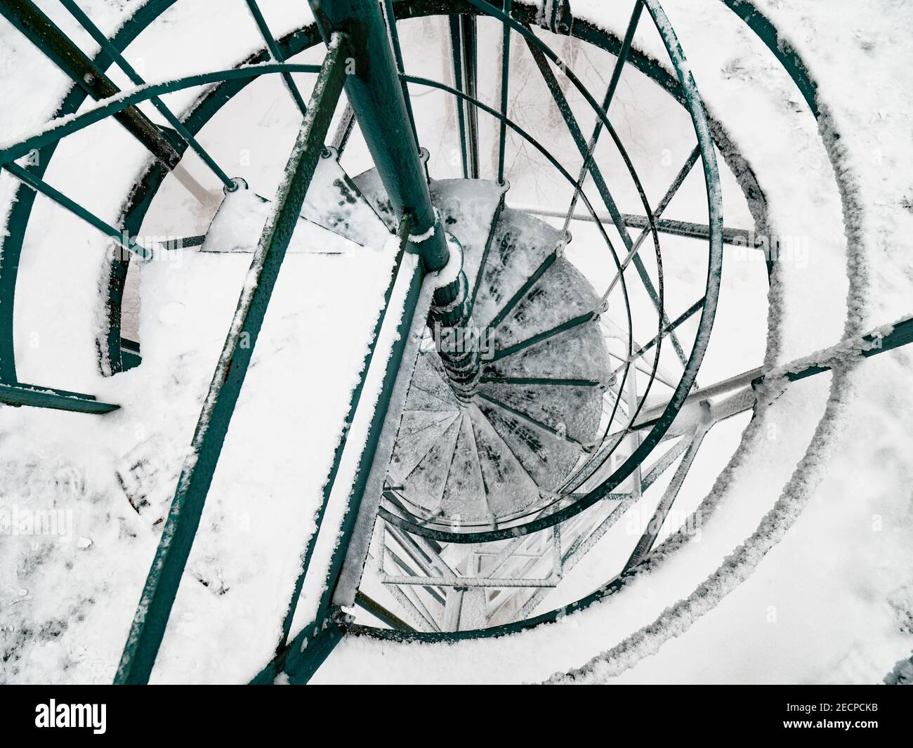 Snowy staircase. Top view of steel winding slippery stairs on a winter ...