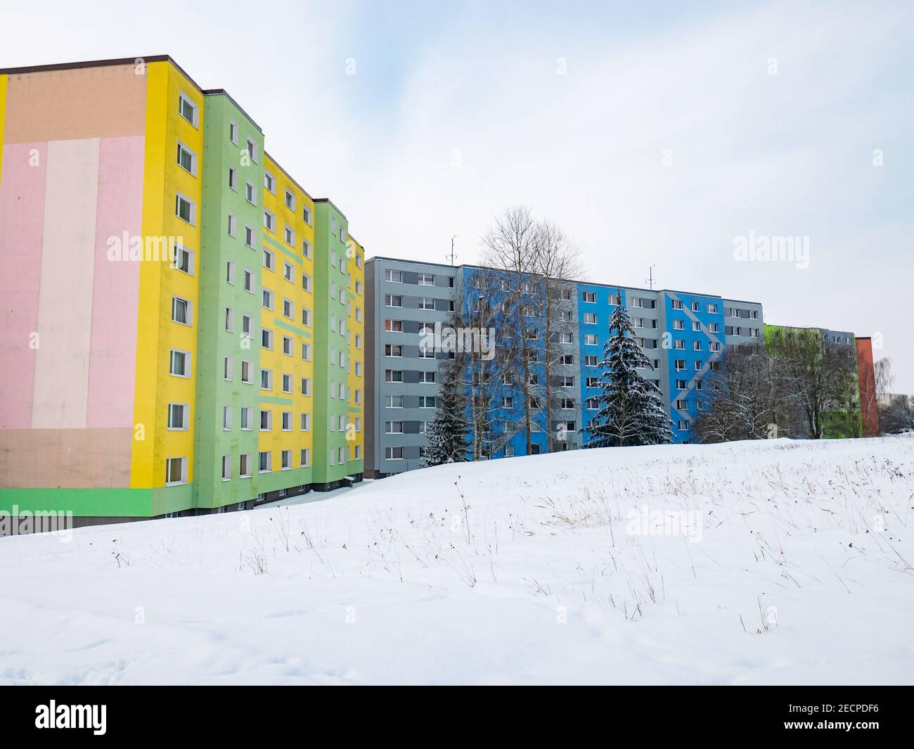 Typical prefabricated construction in white snow. Colorful apartment ...