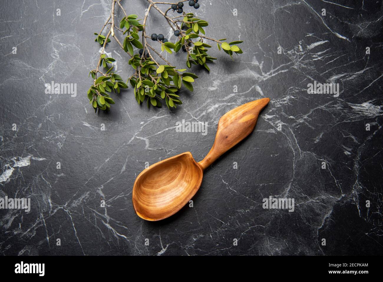 handmade wooden spoon on black marble Stock Photo - Alamy