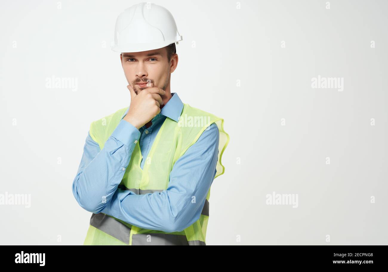 construction worker in white helmet and green reflective vest Stock ...
