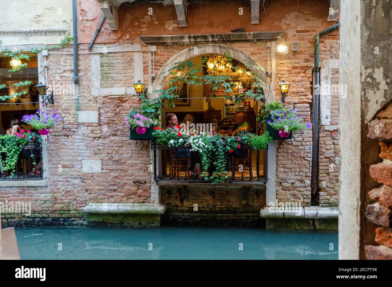 Small restaurant on venetian canal in old house in Venice, Italy ...
