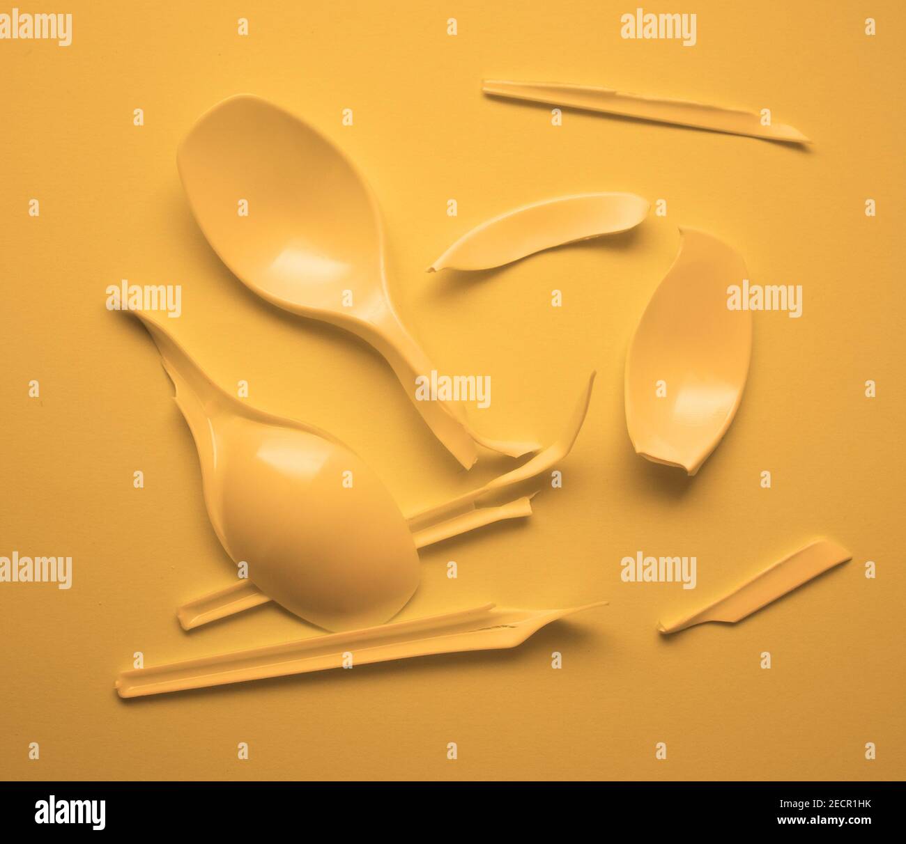 Broken disposable plastic orange spoons. Broken plastic on a orange ...