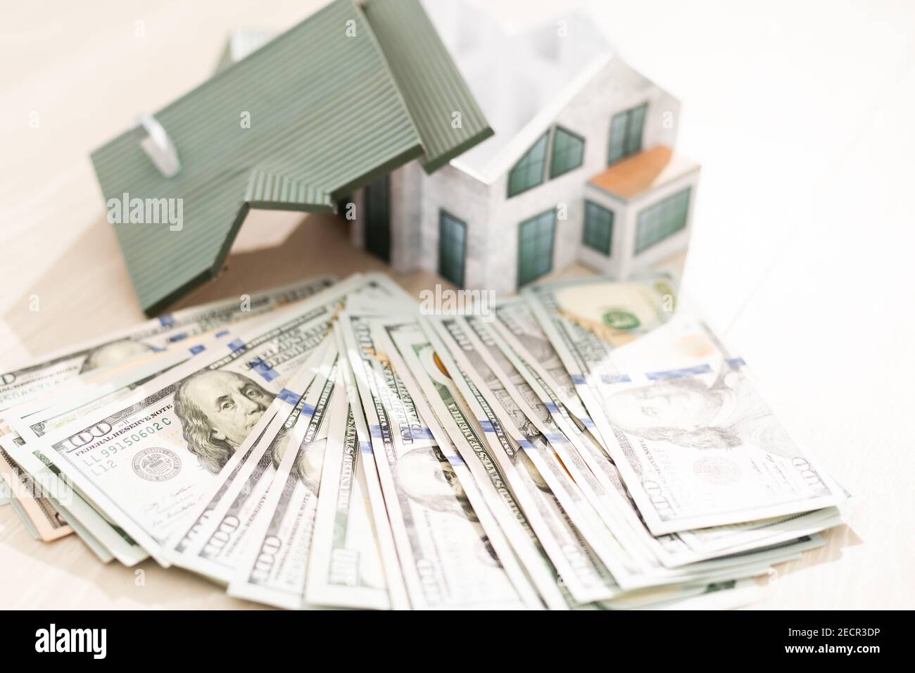 the layout of the house is on a pile of money Stock Photo - Alamy