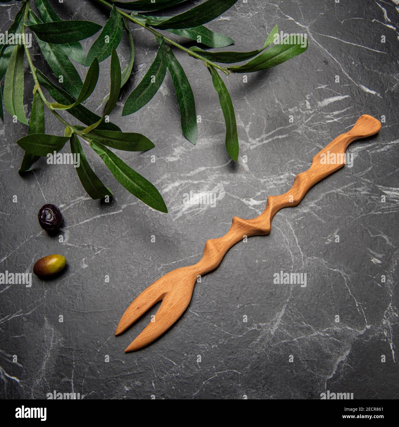 handmade carved wooden fork in the kitchen Stock Photo - Alamy