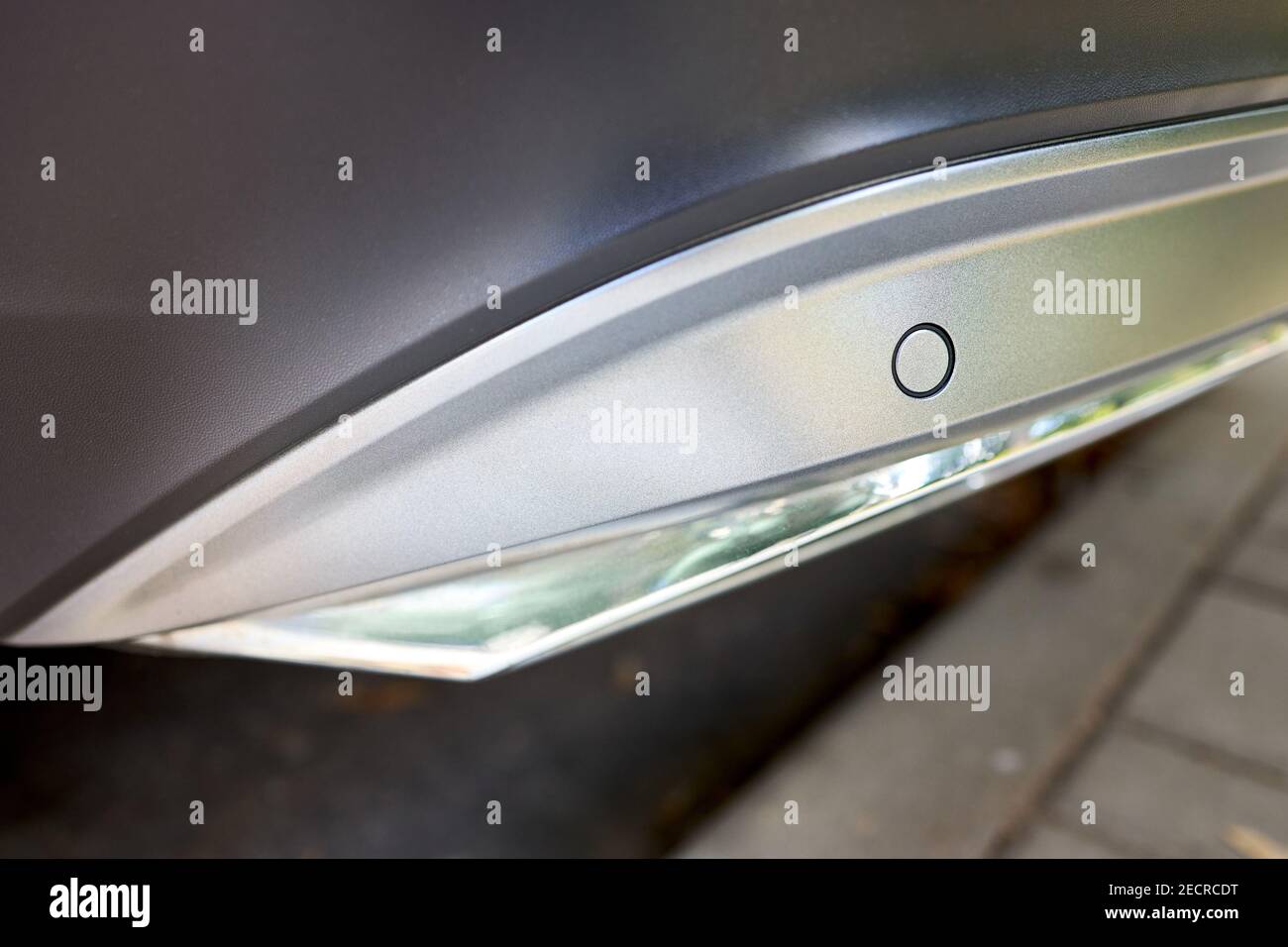 Selective focus on left side of rear bumper parking sensor at back of ...