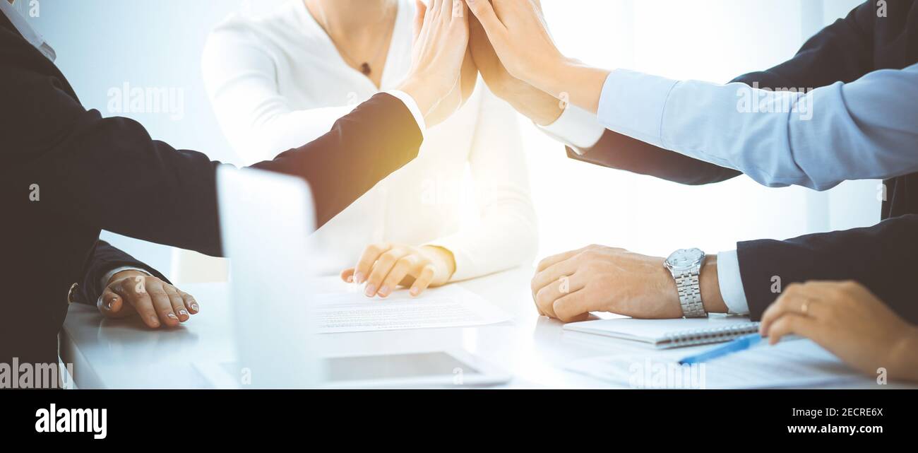 Business people happy showing teamwork and giving five showing unity ...