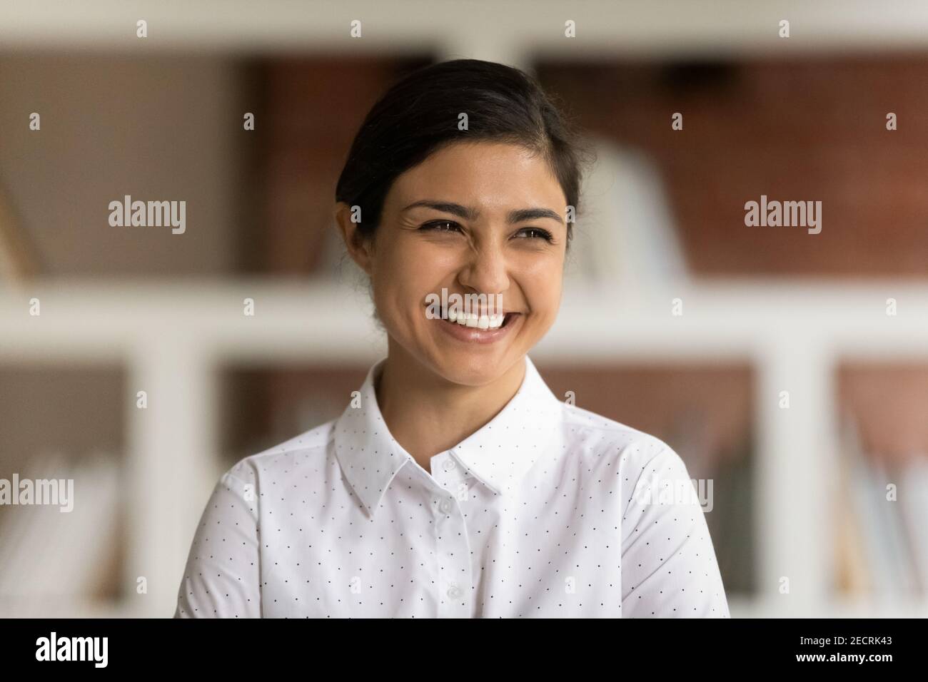 Smiling Indian woman look in distance visualizing Stock Photo - Alamy