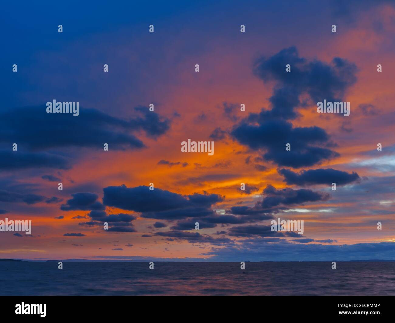 The setting sun lighting up the cloud cover Stock Photo - Alamy