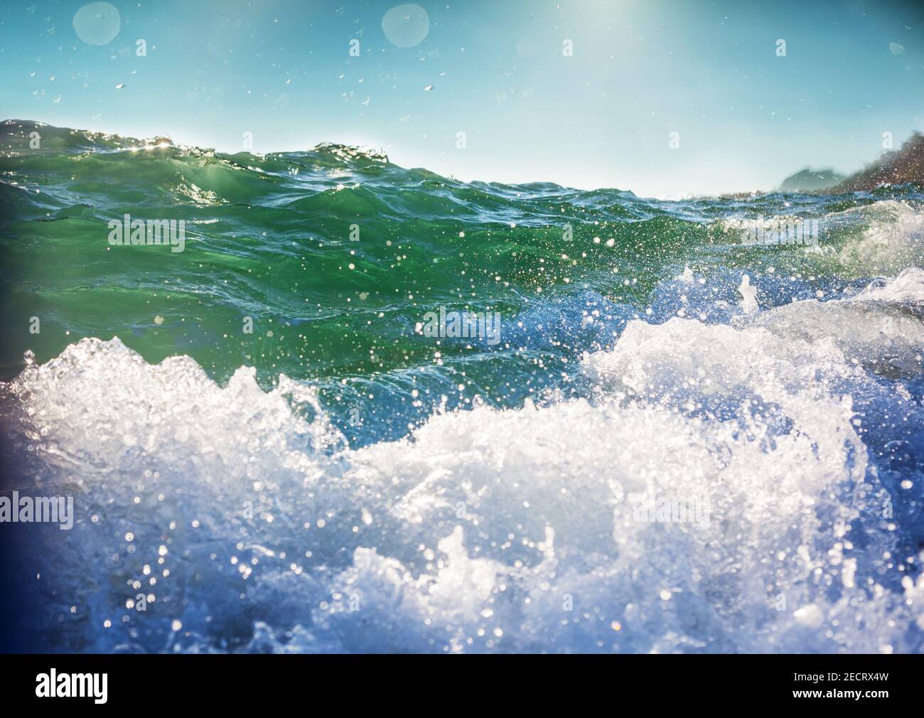 Blue wave on the beach. Blur background and sunlight spots. Dramatic ...