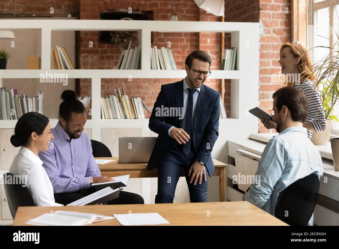 Happy multiracial colleagues have fun at office meeting Stock Photo - Alamy