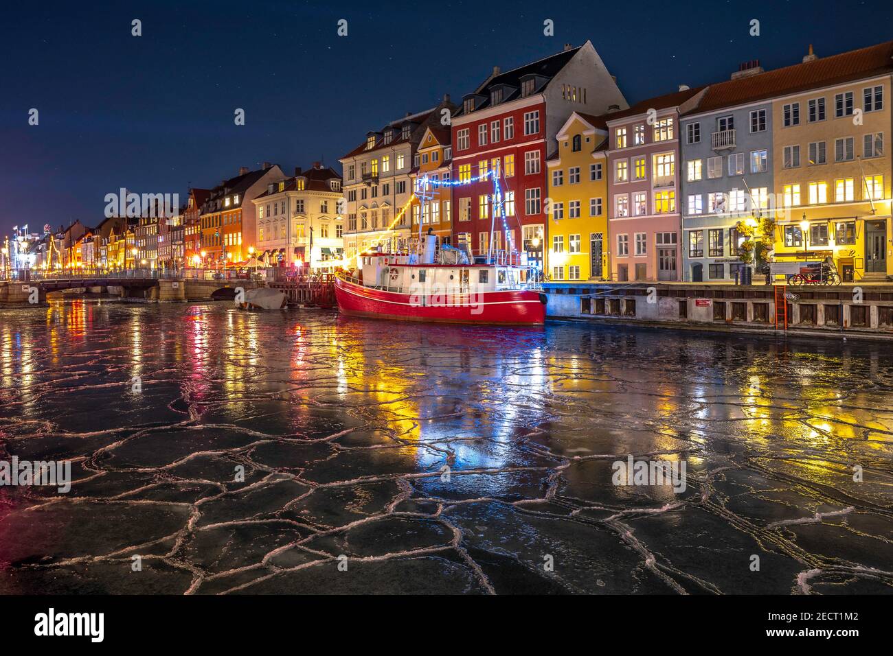 Copenhagen lights festival at night in Nyhavn with the frozen canal ...