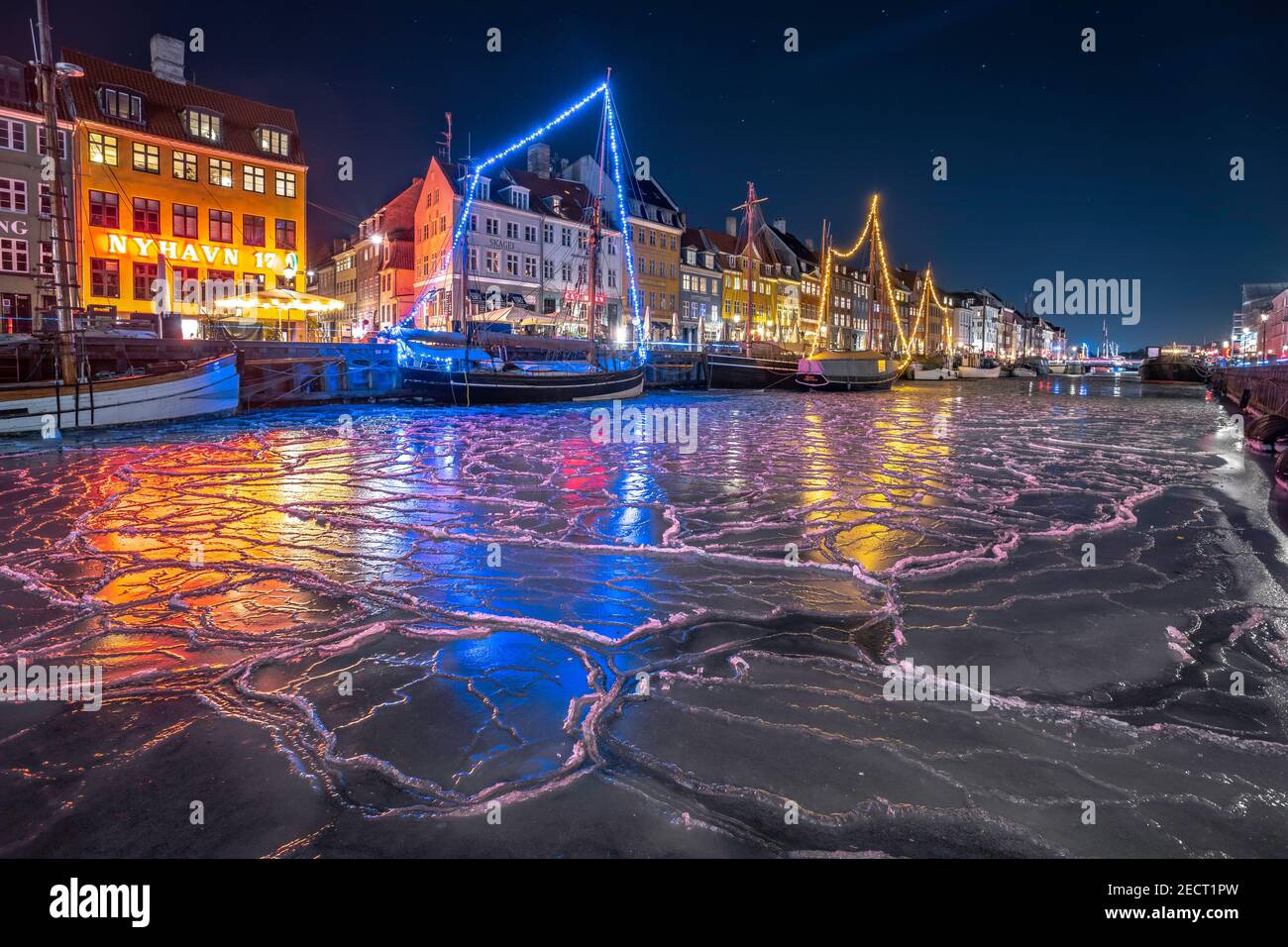 Copenhagen lights festival at night in Nyhavn with the frozen canal ...