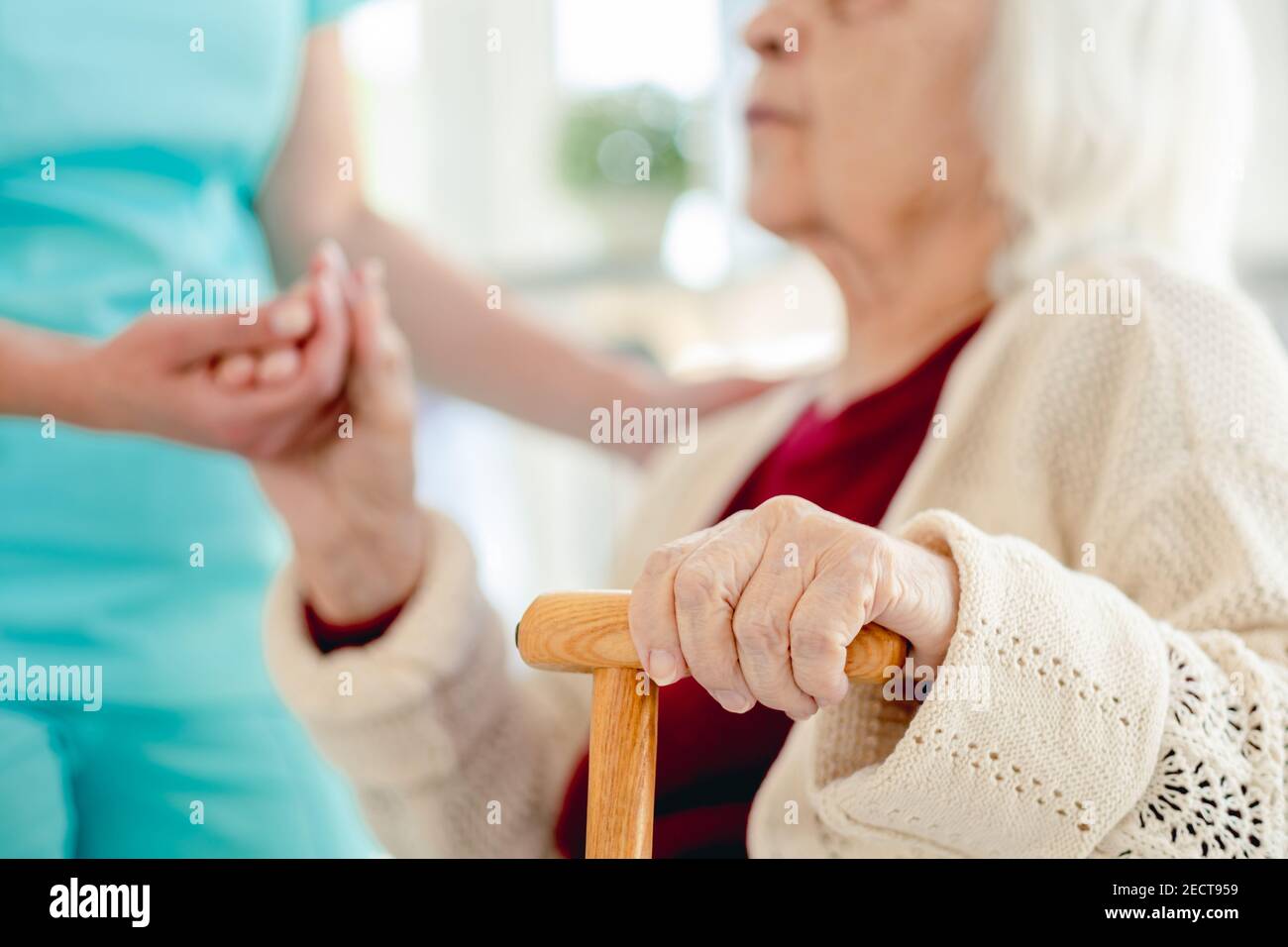 Senior woman hand in caregiver hands Stock Photo - Alamy