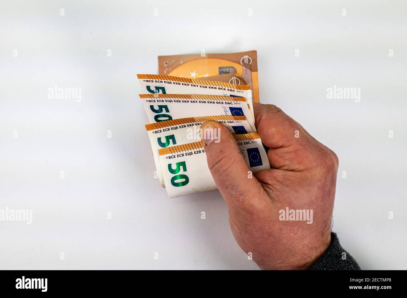 man hand counting 50 euro bills on white background Stock Photo - Alamy