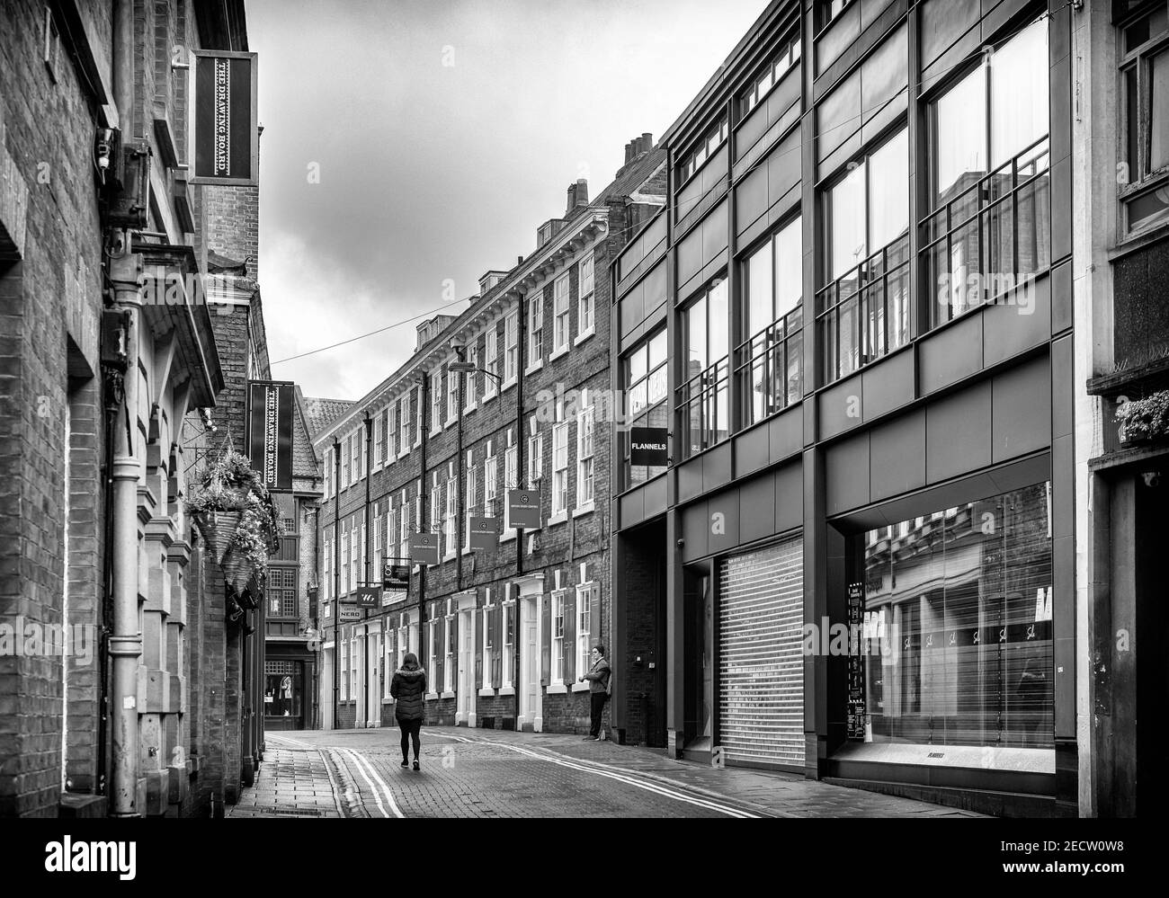 Street scene after a rain shower. Buildings stand on either side of a ...
