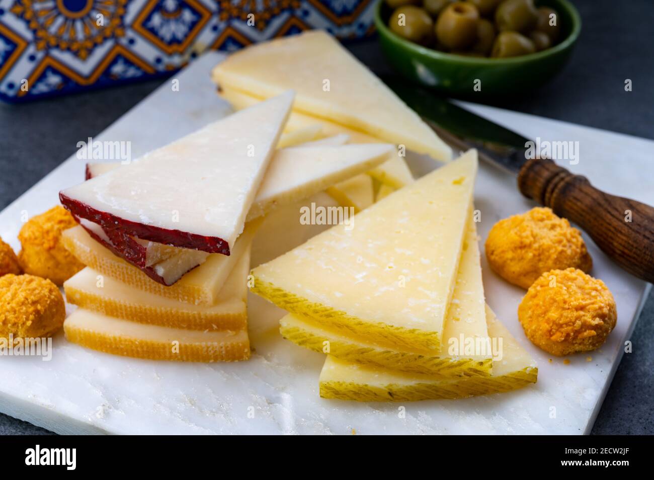 Spanish snacks tapas, variety of sliced goat, sheep, manchego cheeses ...