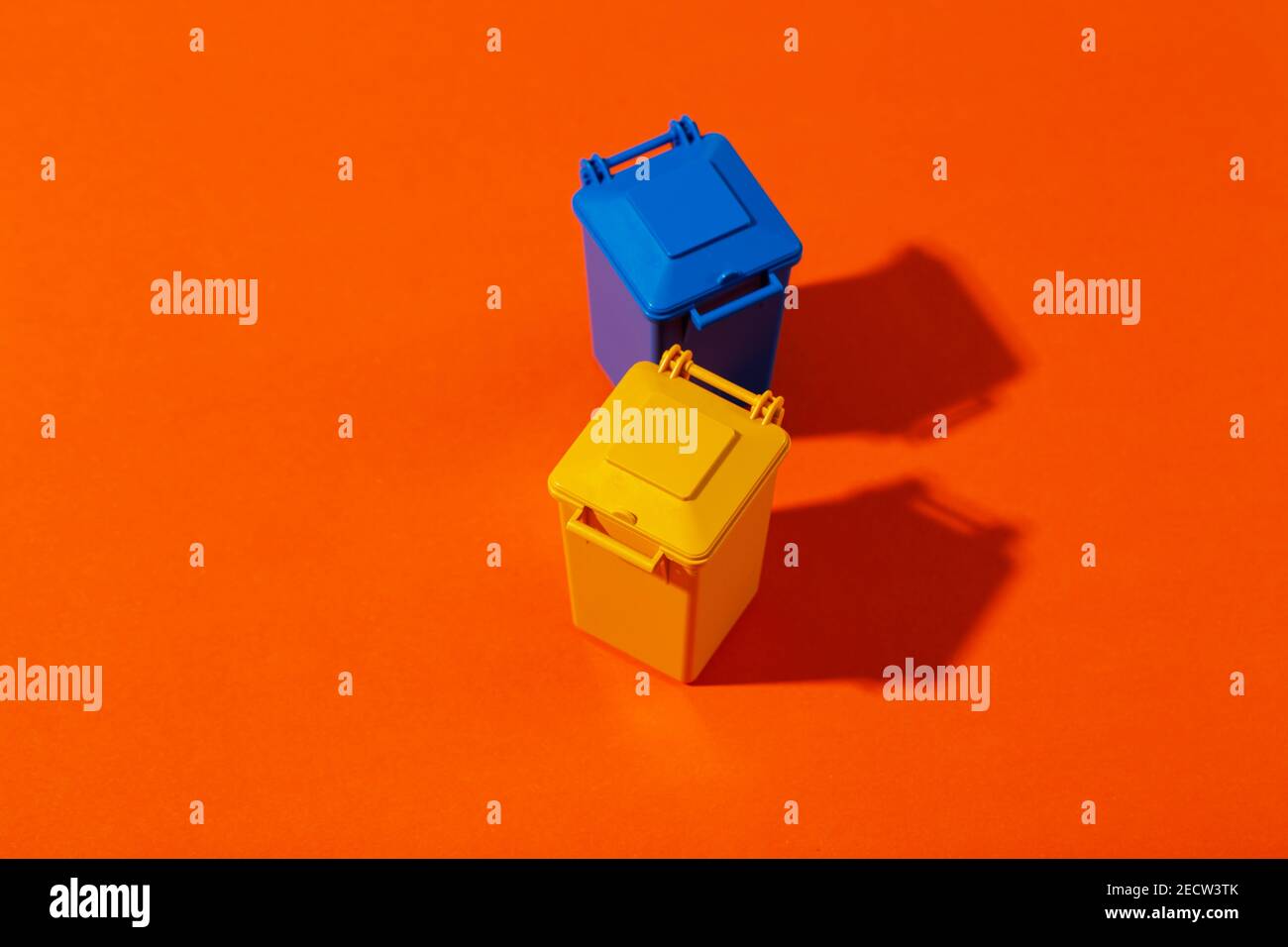 Yellow and blue trash can on an orange background. Infection control ...