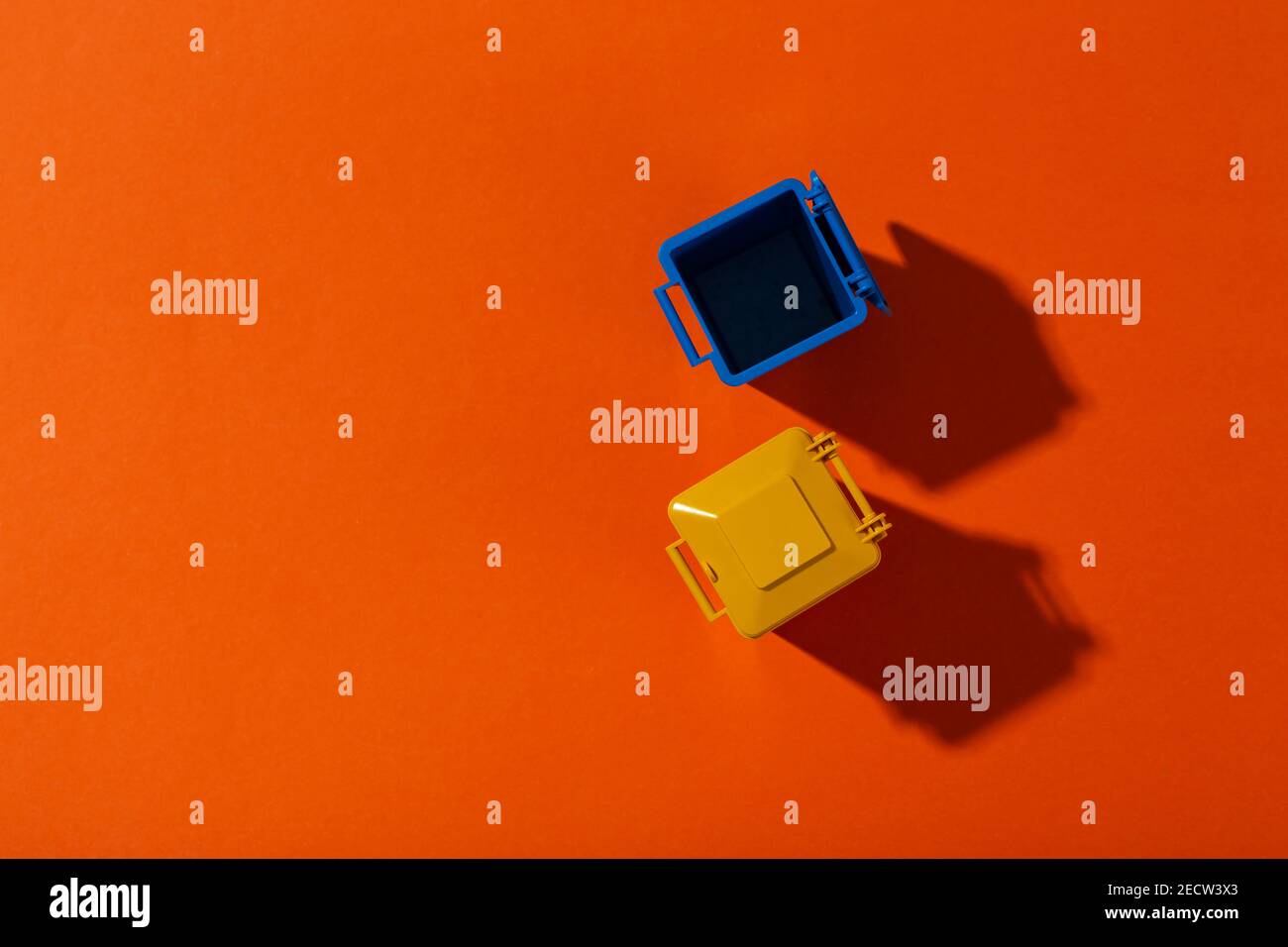 Yellow and blue trash can on an orange background. Infection control ...