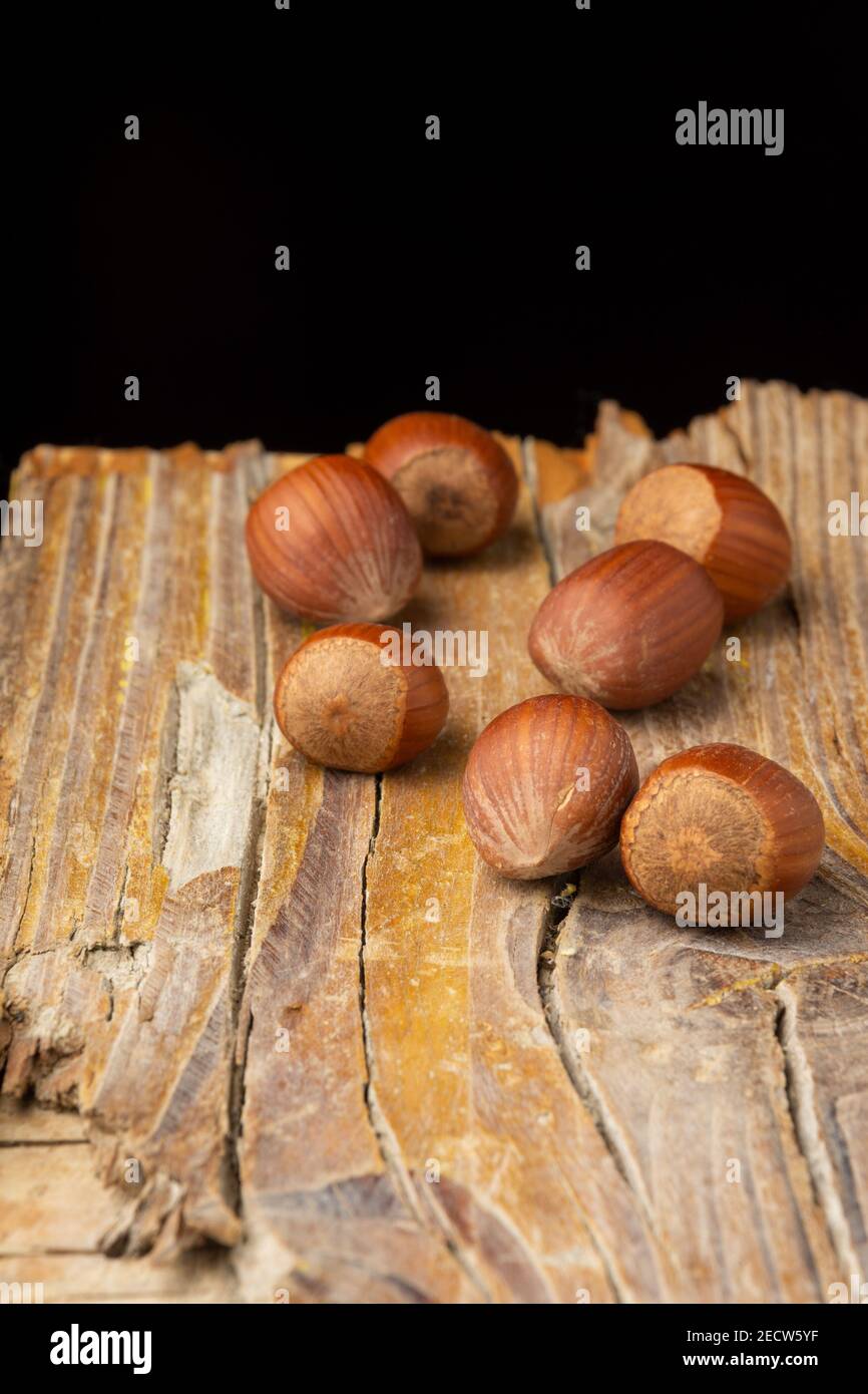 Top view of hazelnuts on rustic wooden table, with selective focus ...