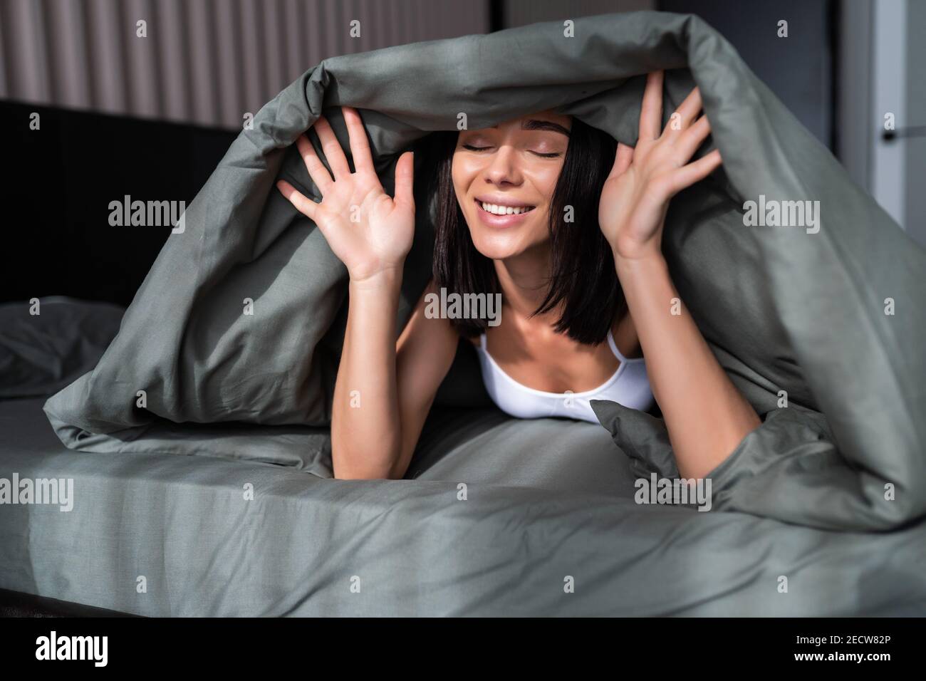 Woman hand under pillow hi-res stock photography and images - Alamy
