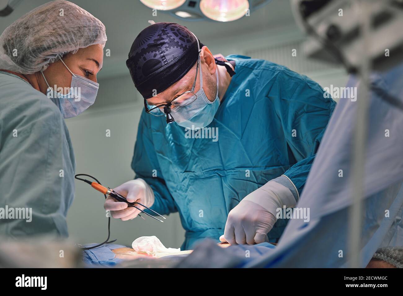 surgeon during liposuction in the operating room Stock Photo - Alamy