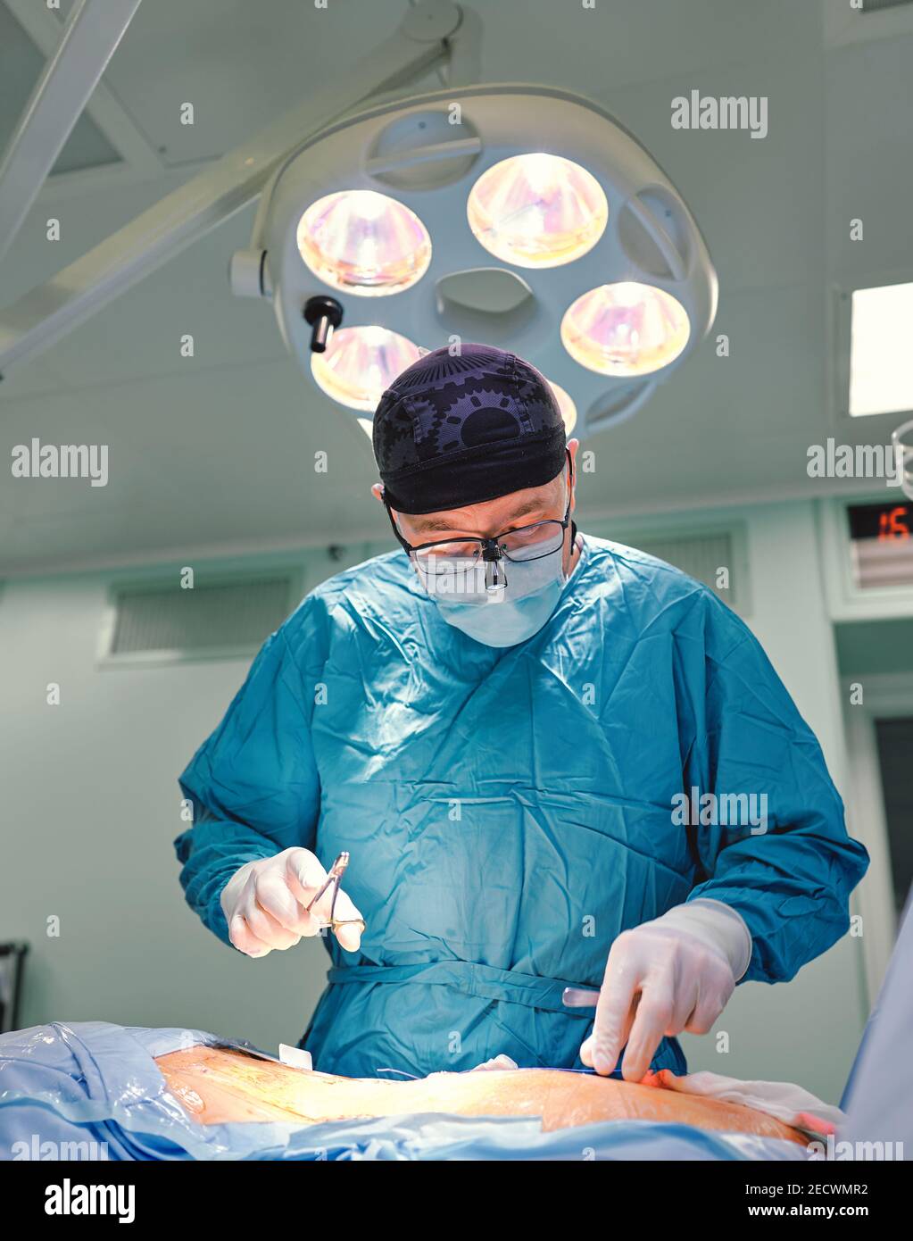 surgeon during liposuction in the operating room Stock Photo - Alamy