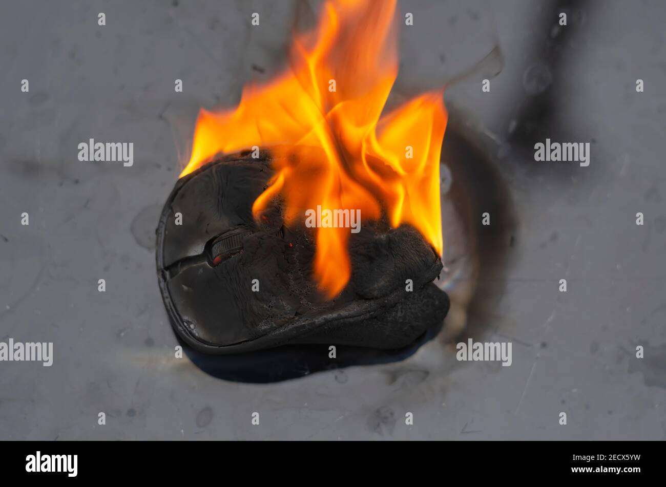Household electrical appliance fire concept. Wireless computer mouse is ...