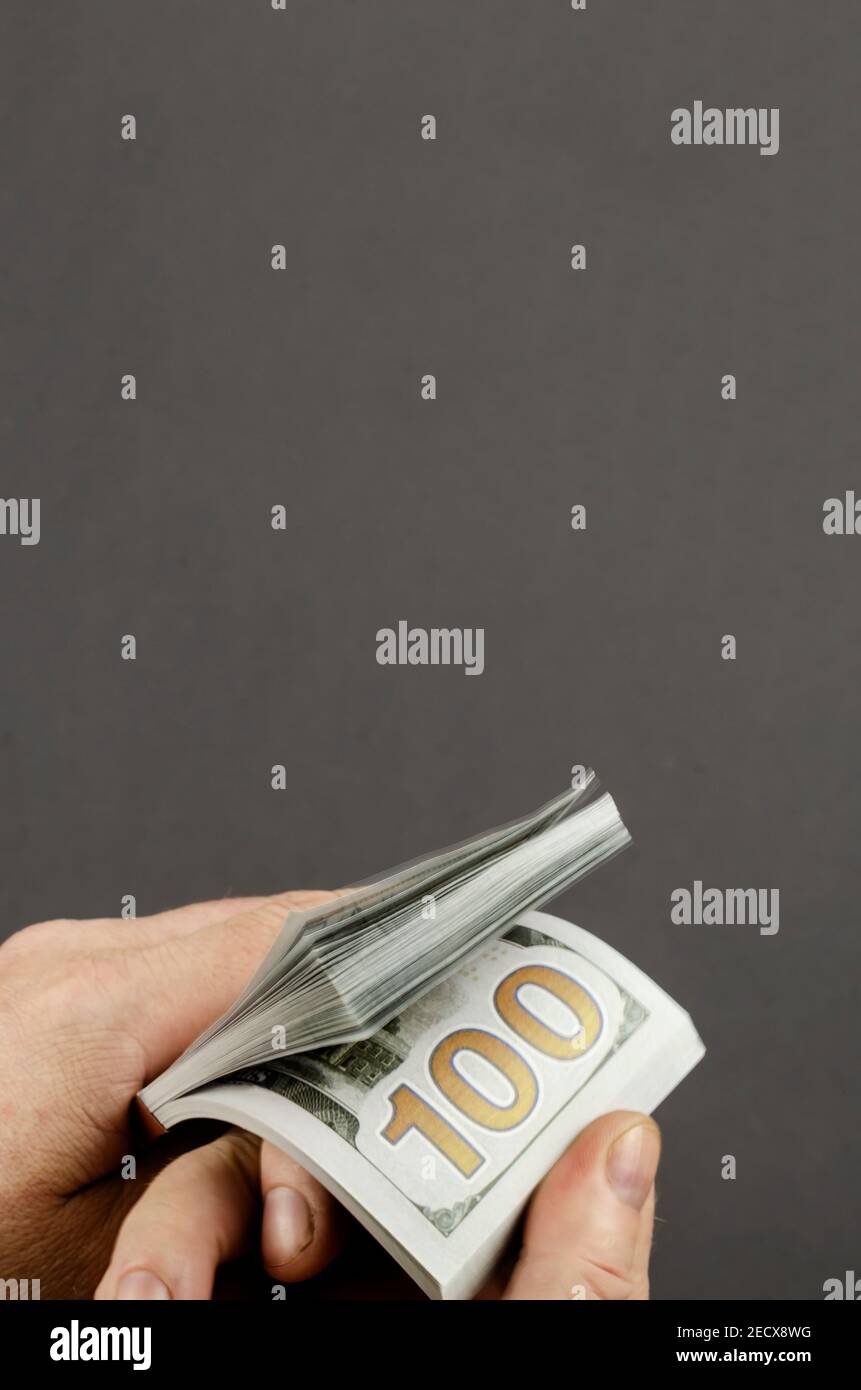 Hand holding $100 bills hi-res stock photography and images - Alamy